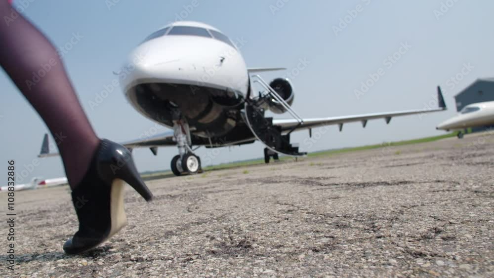 Detail of woman's feet wearing stockings and high heels as she walks ...