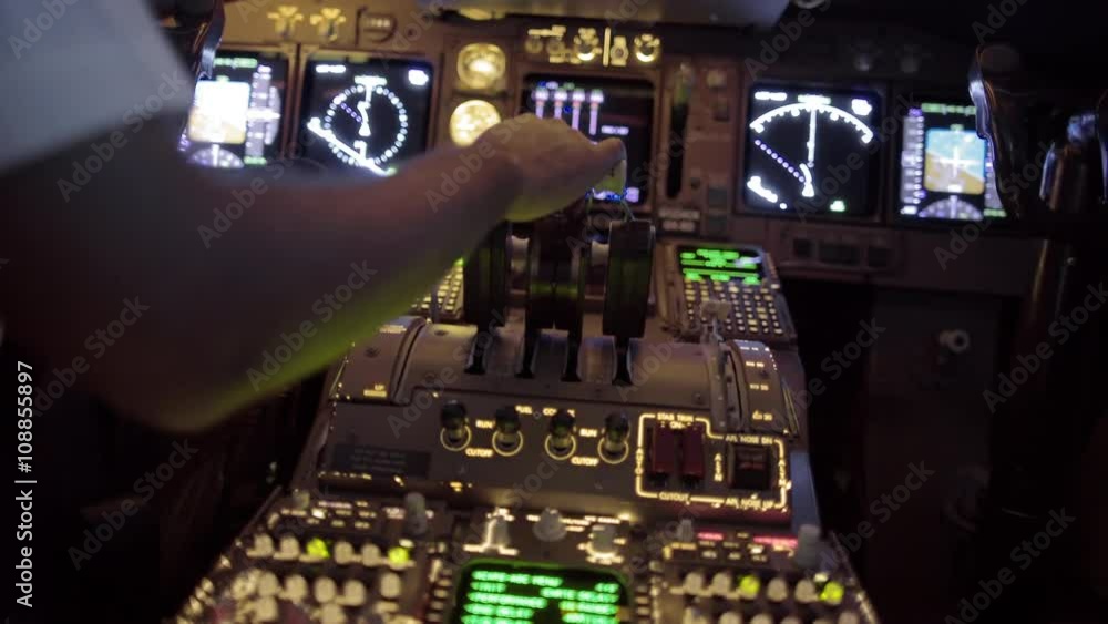 Detail shot of airline pilot pulling back on jet throttles in the ...