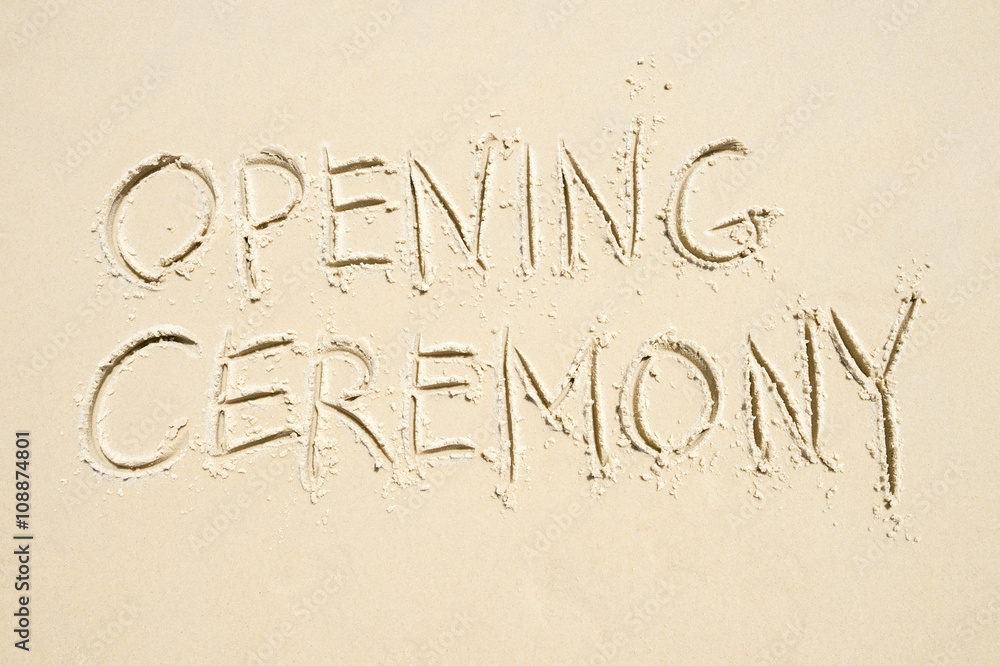 Simple Opening Ceremony message handwritten on smooth sand beach Stock ...