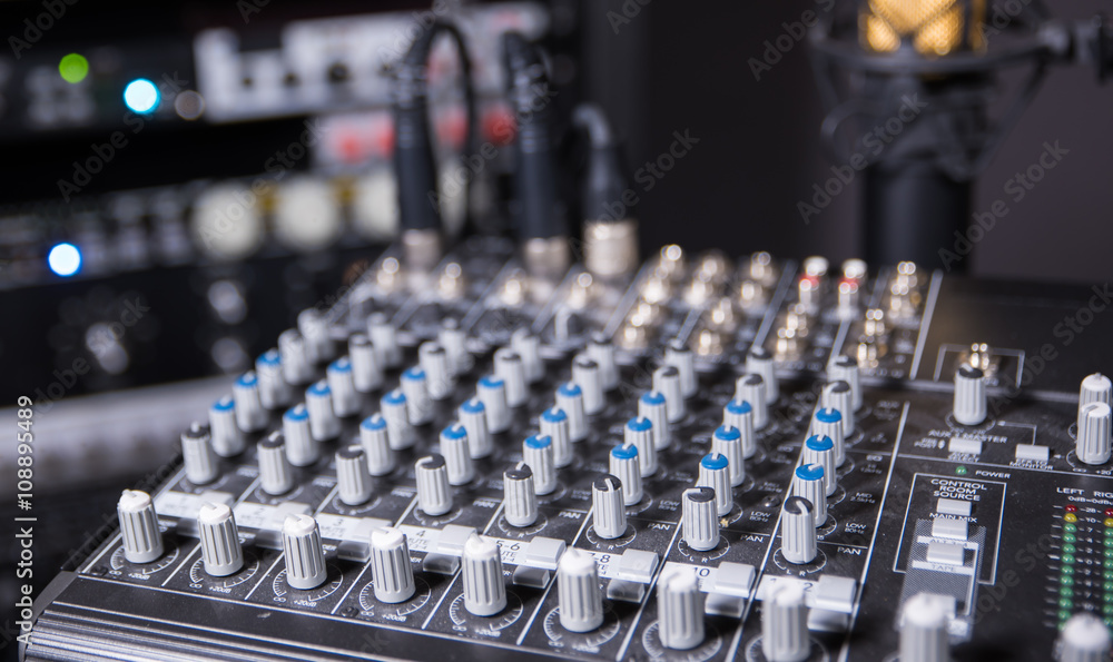 Artistic shot of recording studio mixing board and equipment in the ...