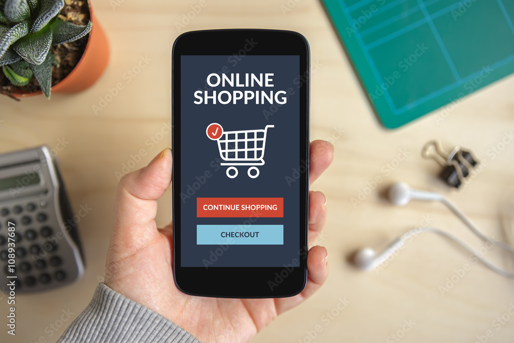 Hand holding smart phone with online shopping concept on screen. All ...