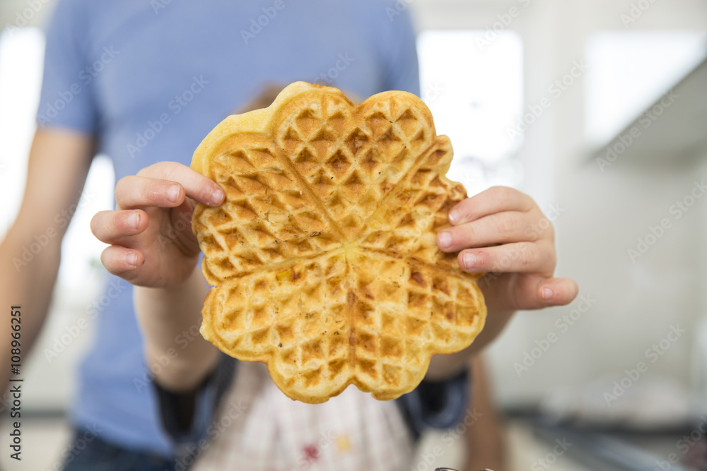 Little boy showing homemade waffle Stock Photo | Adobe Stock