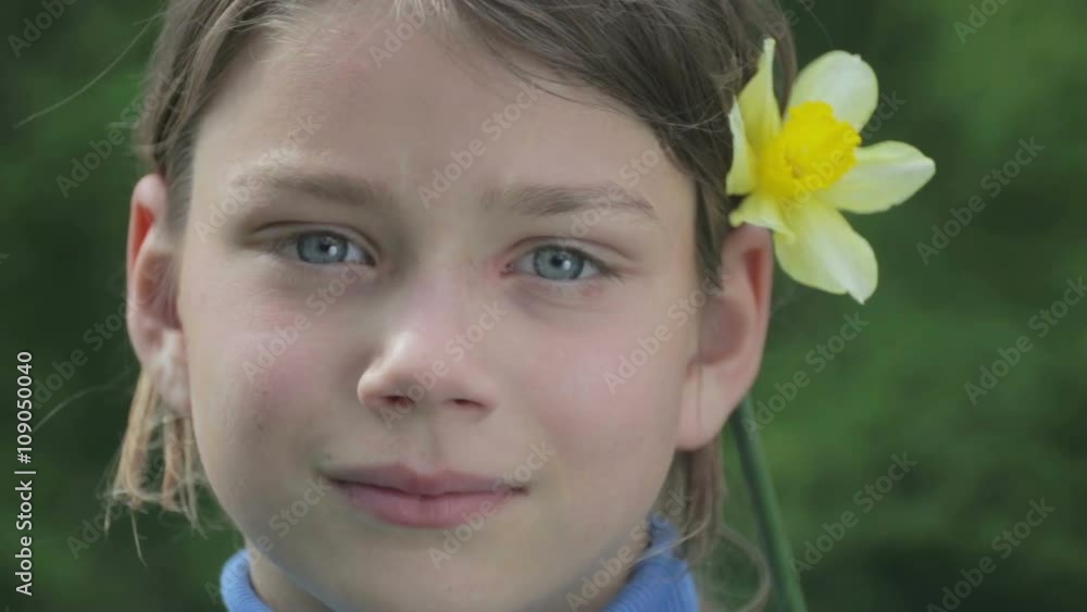 Portrait of a boy in the spring with a flower of yellow narcissus ...