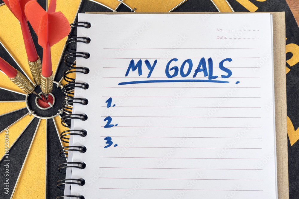 Words my goals on recycle notebook with three dart on bullseye target ...