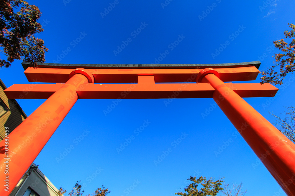 A giant torii gate in front of the Romon Gate at the shrine's entrance ...