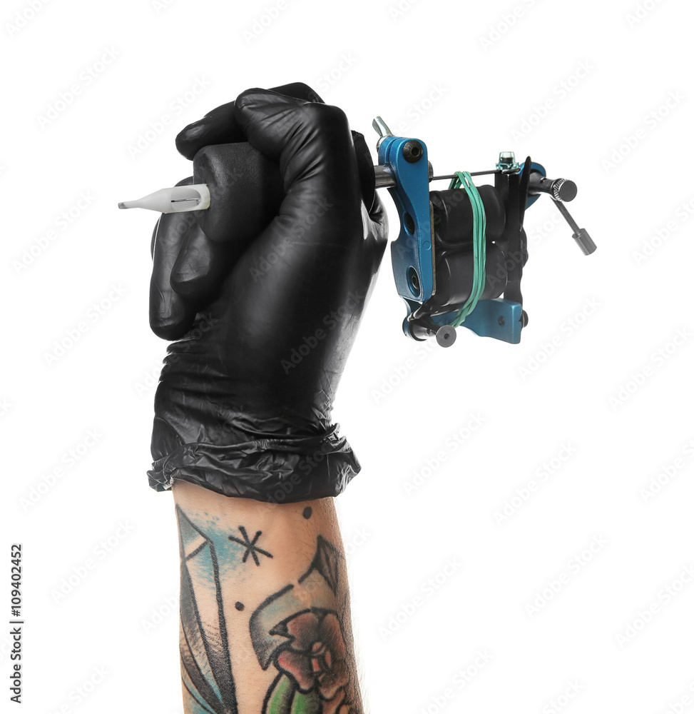 Man's hand holding tattoo machine on white background Stock Photo ...