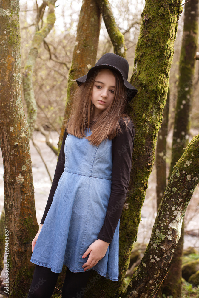 Teenage Girl Leaning On Tree