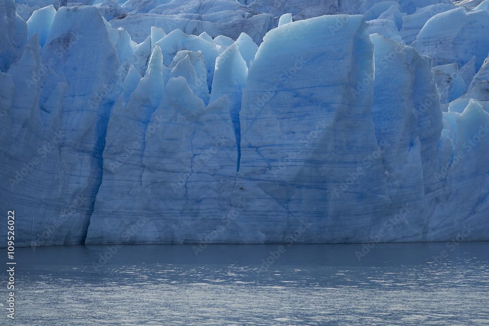 Blue ice cliff of Glacier Grey as it flows into Lago Grey in Torres del ...