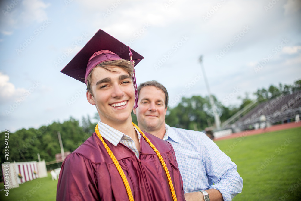 Young man standing with father at graduation ceremony Stock Photo ...
