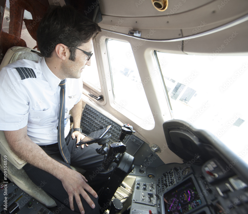 Male pilot looking through cockpit window of private jet Stock Photo ...
