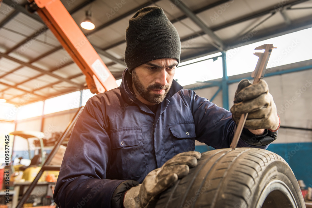 Mechanic, checking a measurement gauge to check the depth of a t Stock ...