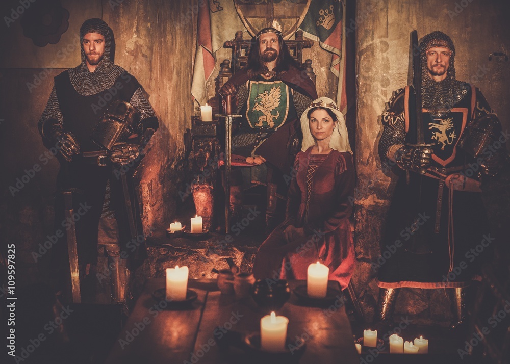 Medieval king with his queen and knights on guard in ancient castle ...