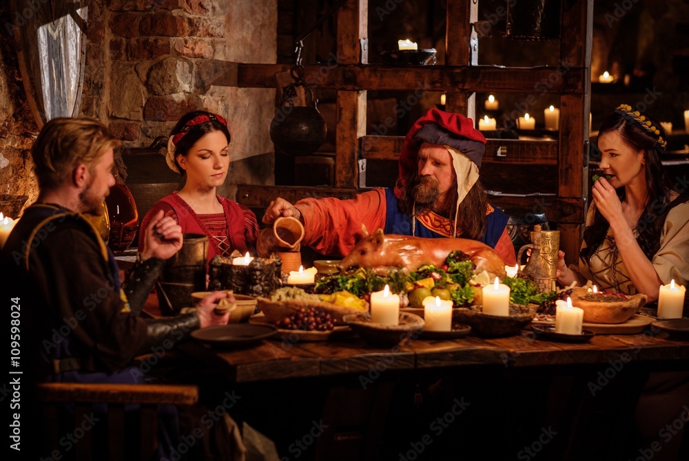 Medieval people eat and drink in ancient castle kitchen interior. Stock ...