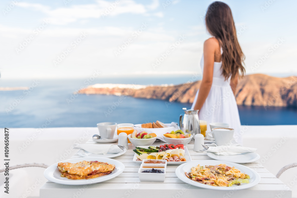 Breakfast table and luxury travel woman on santorini. Well balanced ...