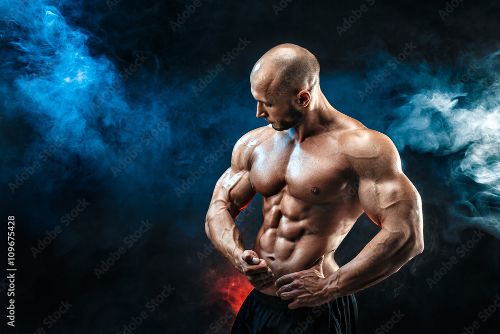 Strong bodybuilder man with perfect abs, shoulders,biceps, triceps ...