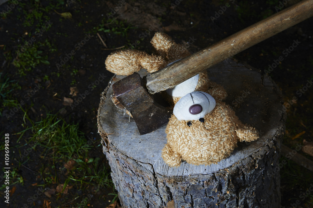 execution a teddy bear toy with an ax Stock Photo | Adobe Stock