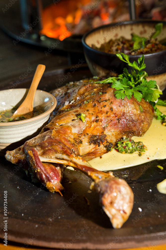 Delicious free range roasted goat shoulder served on a rustic metal ...