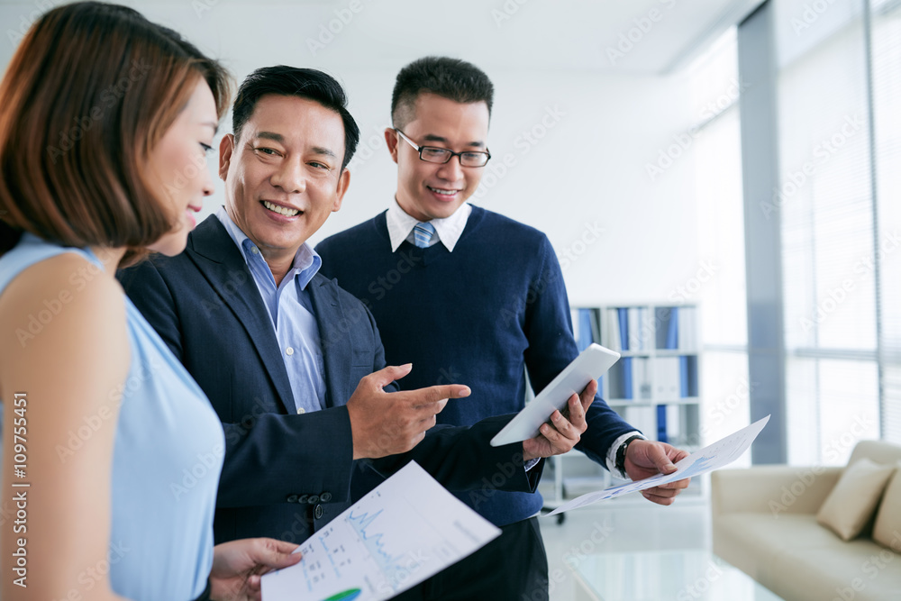 Group of Asian people discussing charts Stock Photo | Adobe Stock