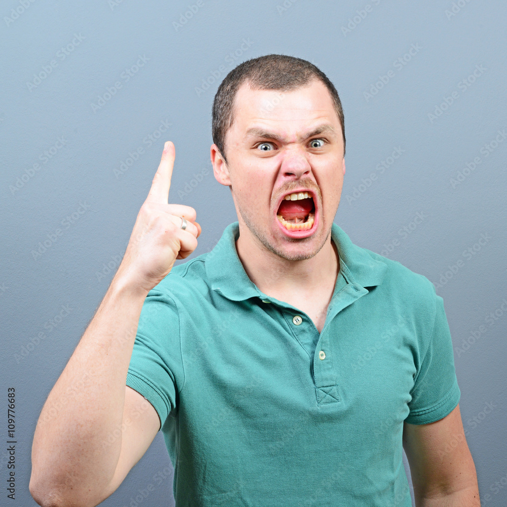 Portrait of a angry threatening man screaming against gray backg Stock ...