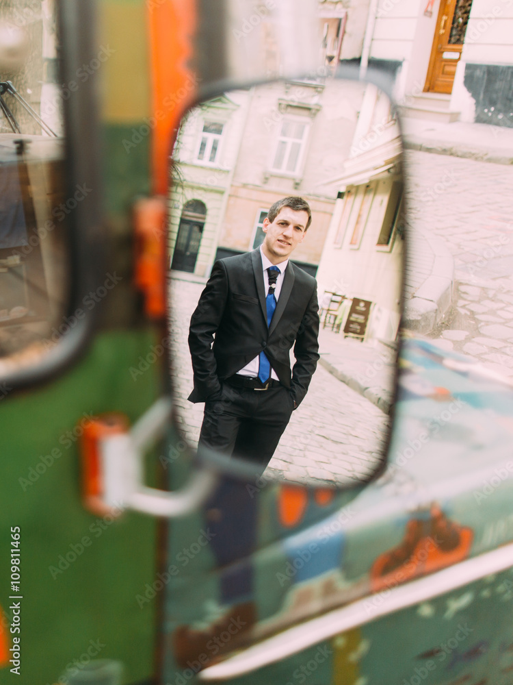 Handsome caucasian business man in black suit looking at camera through ...
