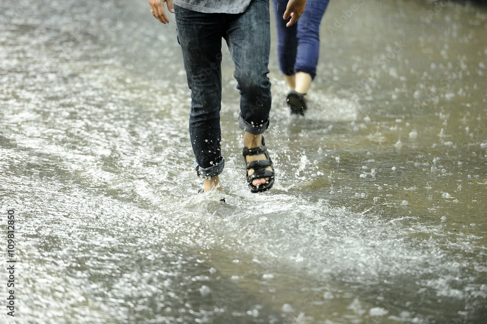 People walking in the rain in a summer day Stock Photo | Adobe Stock