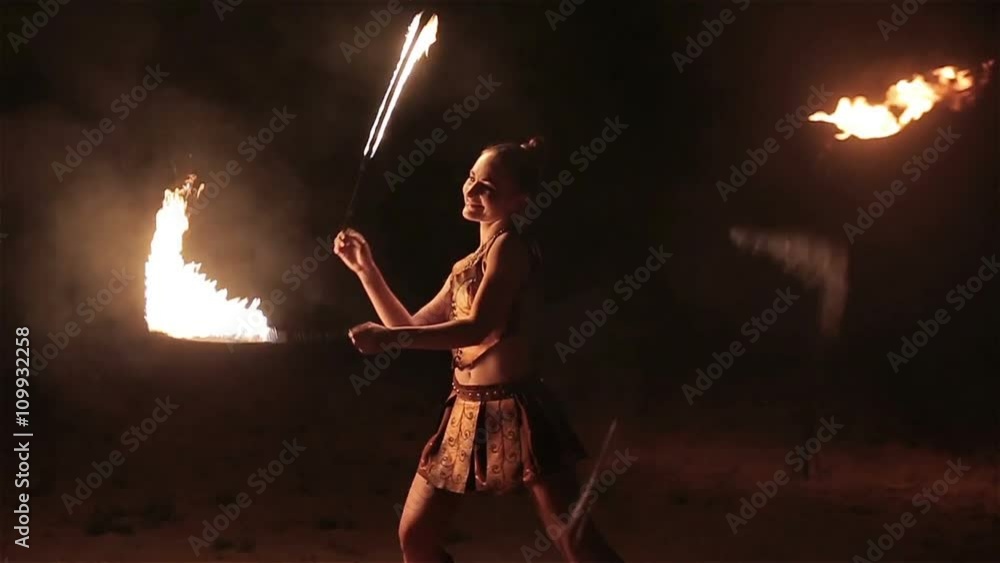 Fire show performance. Sexy woman female fire performer dance twirling ...