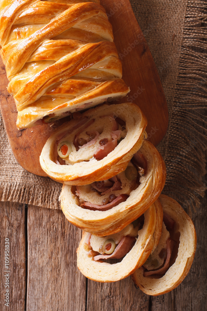 Venezuelan bread pan de jamon close-up on the table. Vertical top view ...