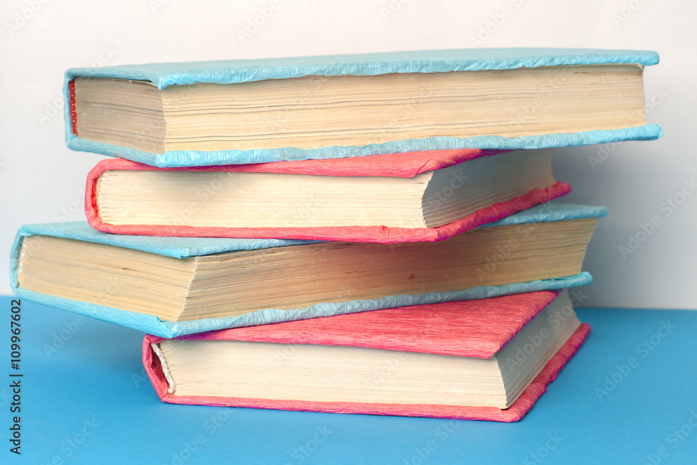 Stack of colorful books, grungy blue background, free copy space ...