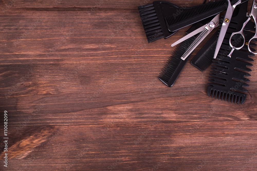 Professional hairdressing equipment on a dark wooden background. Tools ...