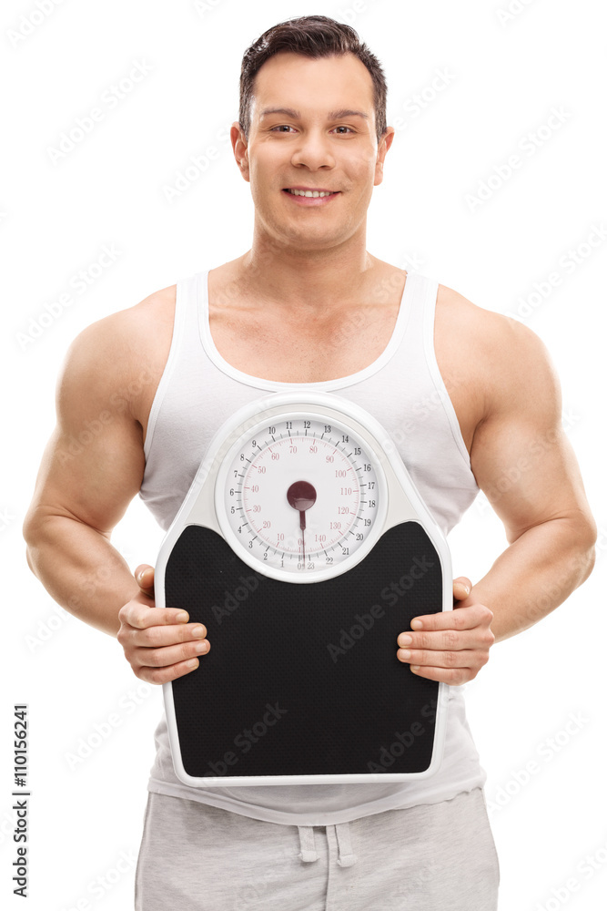 Muscular man holding a weight scale Stock Photo | Adobe Stock