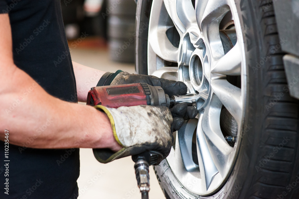 removing bolt from a wheel using pneumatic gun, tire replacement Stock ...
