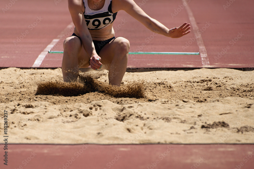 Landing in long jump in track and field Stock Photo | Adobe Stock