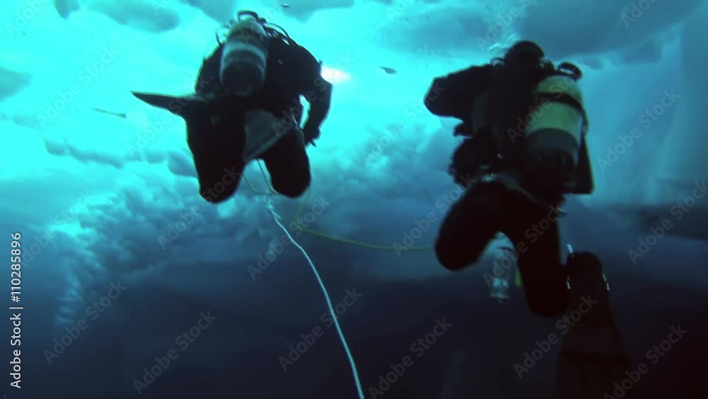 Unique extreme underwater shooting scuba dive beneath ice at geographic ...