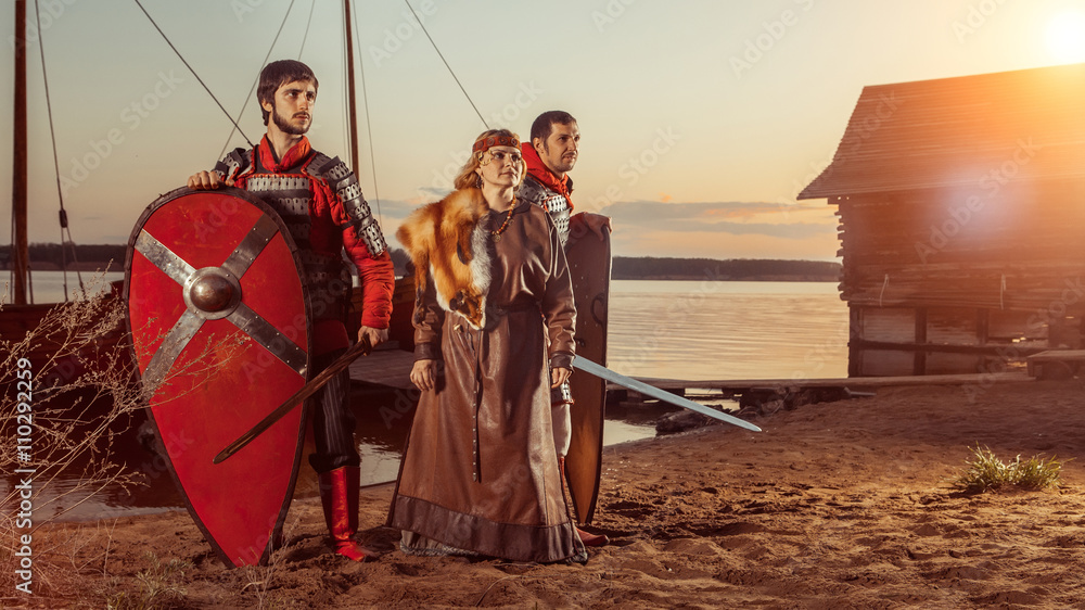 Slavic princess and two warriors with swords and shields on the ...