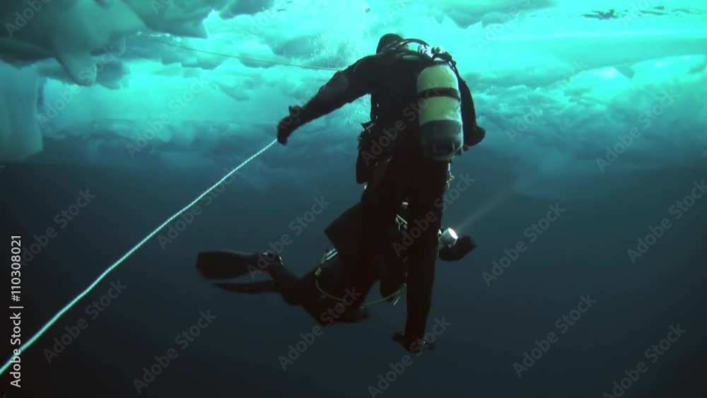 Unique extreme underwater shooting scuba dive beneath ice at geographic ...