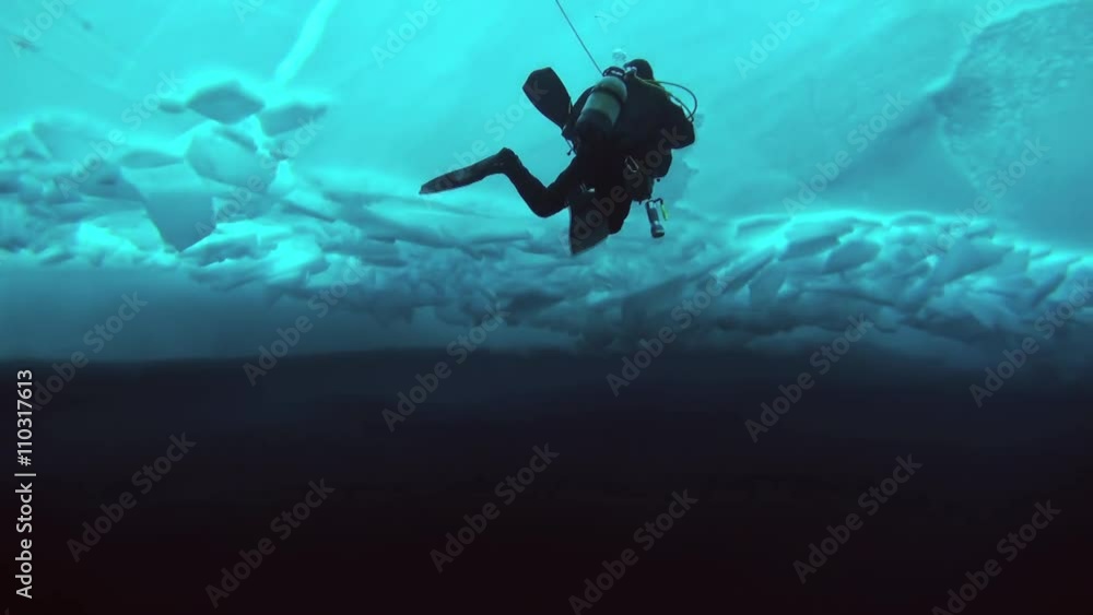Unique extreme underwater shooting scuba dive beneath ice at geographic ...