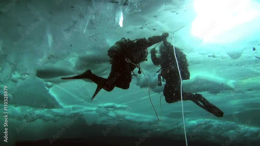 Unique extreme underwater shooting scuba dive beneath ice at geographic ...