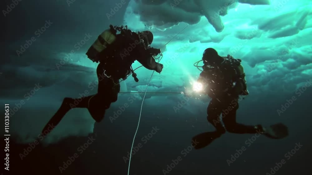 Unique extreme underwater shooting scuba dive beneath ice at geographic ...