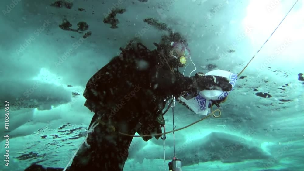 Unique extreme underwater shooting scuba dive beneath ice at geographic ...