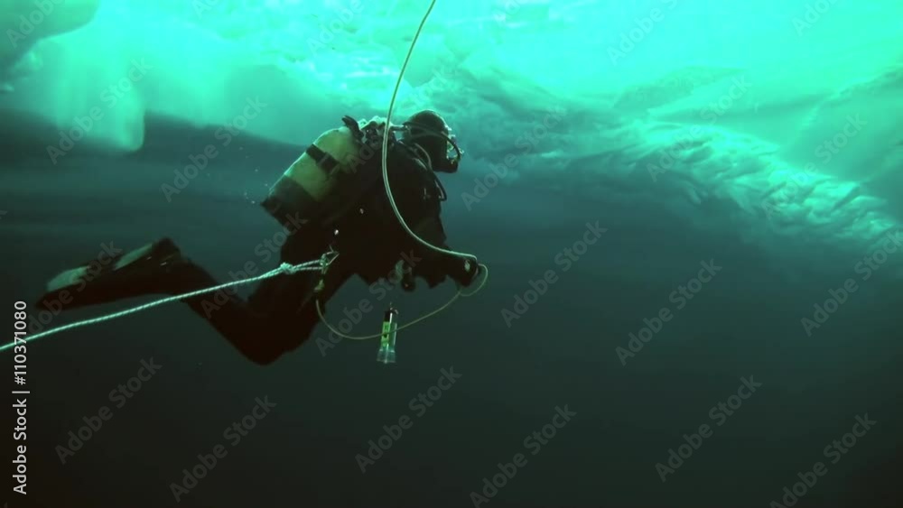 Unique extreme underwater shooting scuba dive beneath ice at geographic ...
