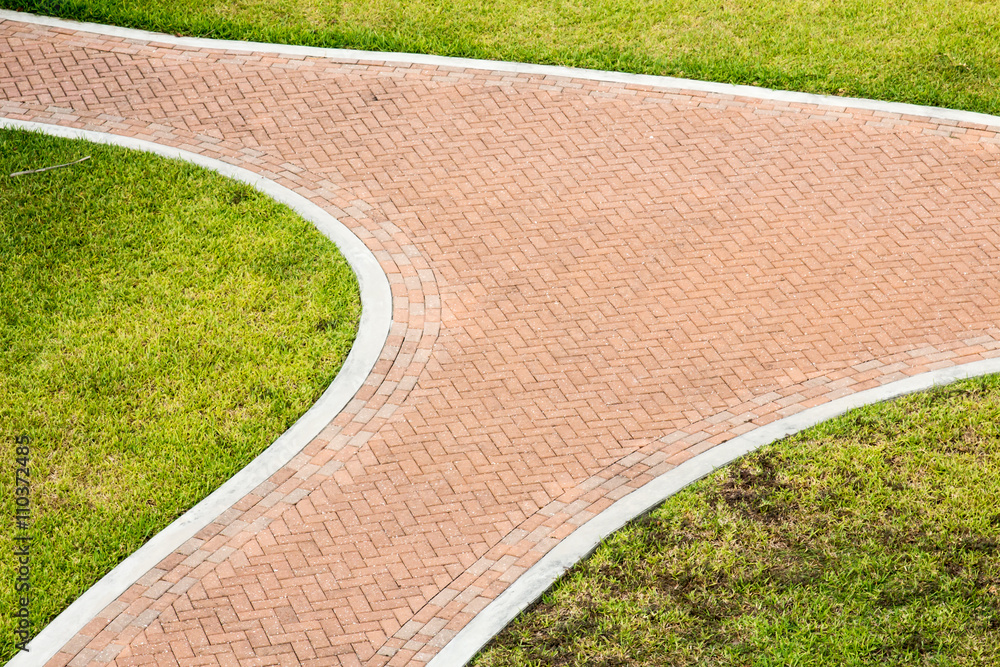 Brick pathway going in three directions through grass Stock Photo ...