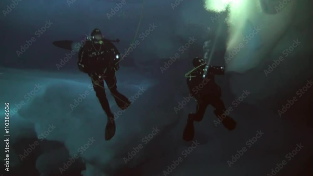 Unique extreme underwater shooting scuba dive beneath ice at geographic ...