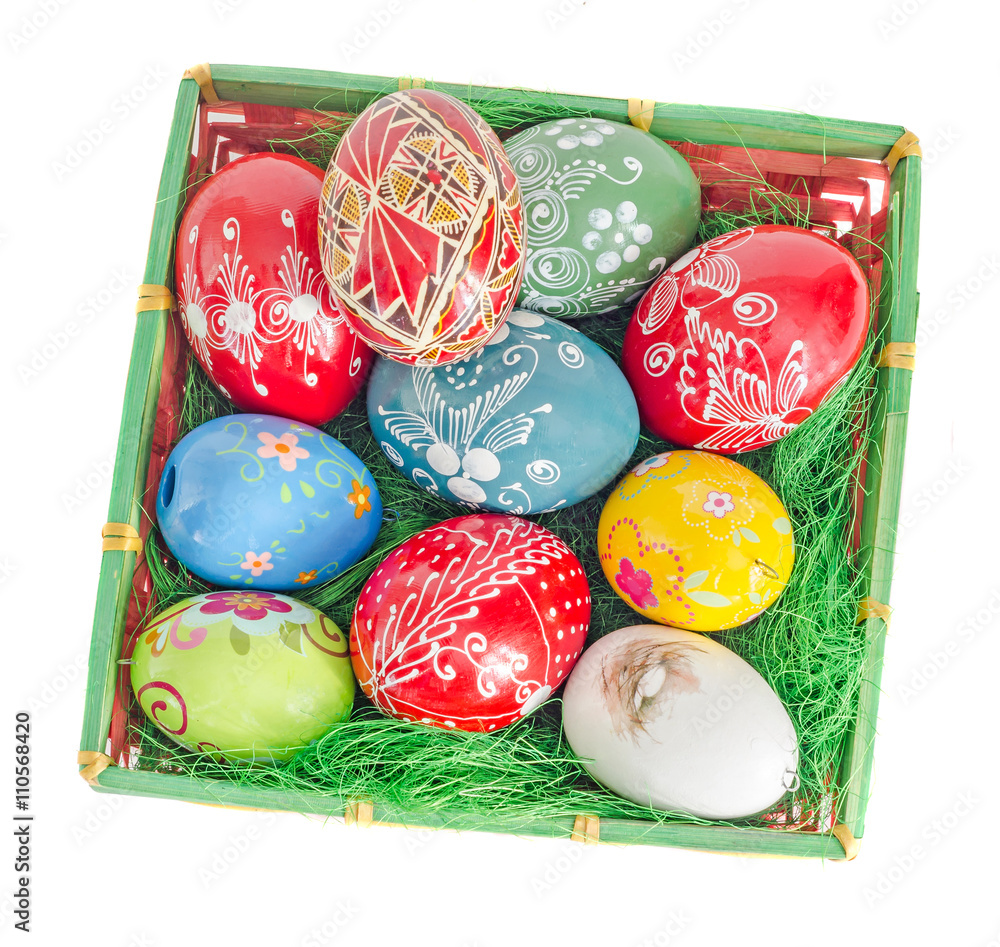 Colored romanian traditional Easter eggs in a basket with green grass ...