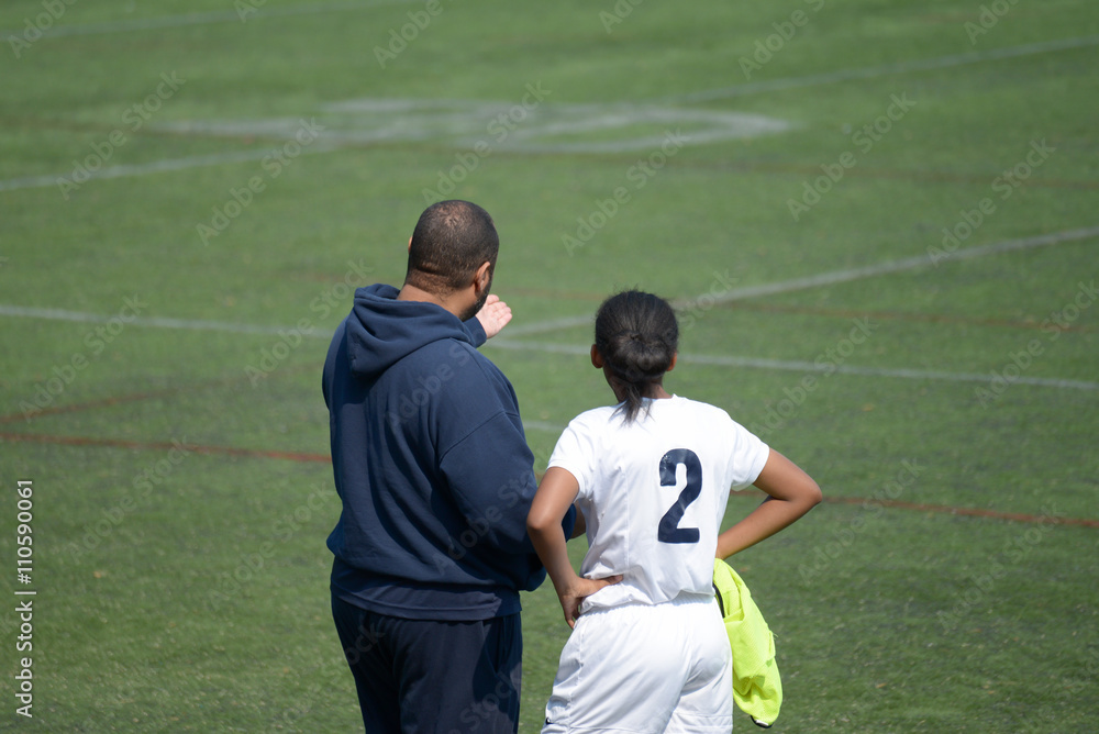 Coach Giving Instructions On Sideline Stock Photo | Adobe Stock