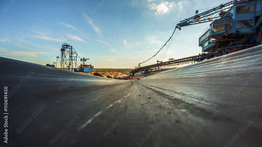 Long conveyor belt transporting ore Stock Photo | Adobe Stock
