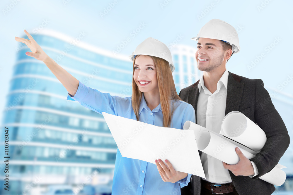 Two architects at work on blurry business center background background ...