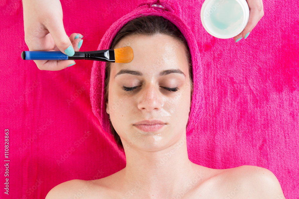 Beautiful young girl getting cream mask in spa salon Stock Photo ...