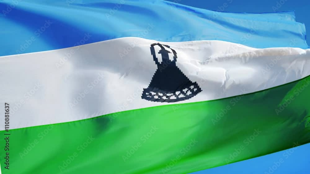 Lesotho flag waving in slow motion against clean blue sky, seamlessly ...