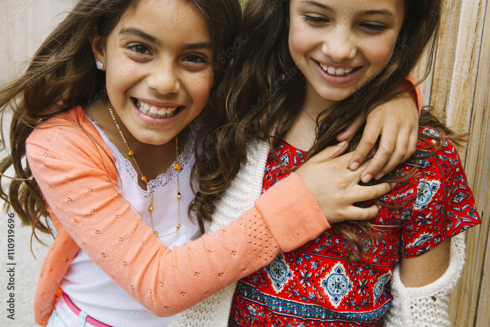 Two girls with arms around each other Stock-Foto | Adobe Stock