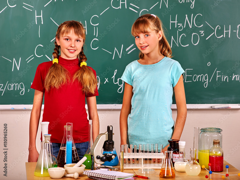 Happy children holding flask in chemistry class. Children in chemistry ...